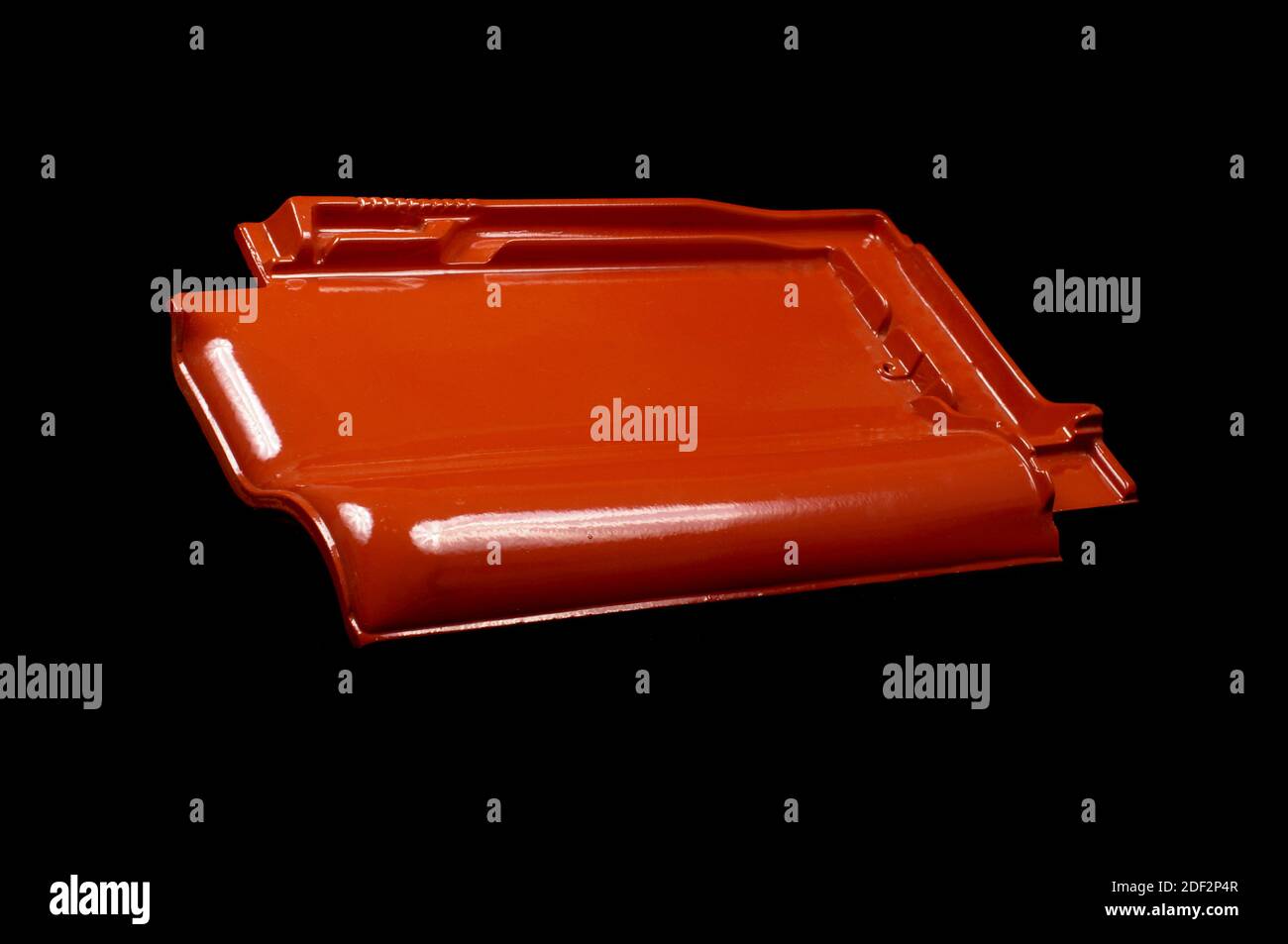 Single new shinny red roof tile isolated on the black background Stock ...