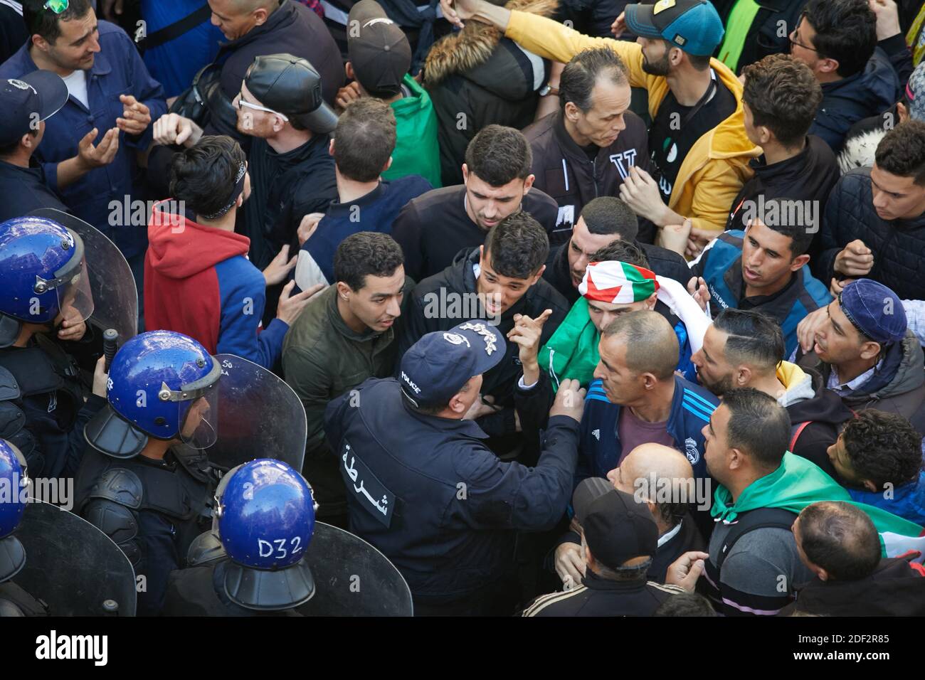 Algerian riot police block the progress of an anti-government ...