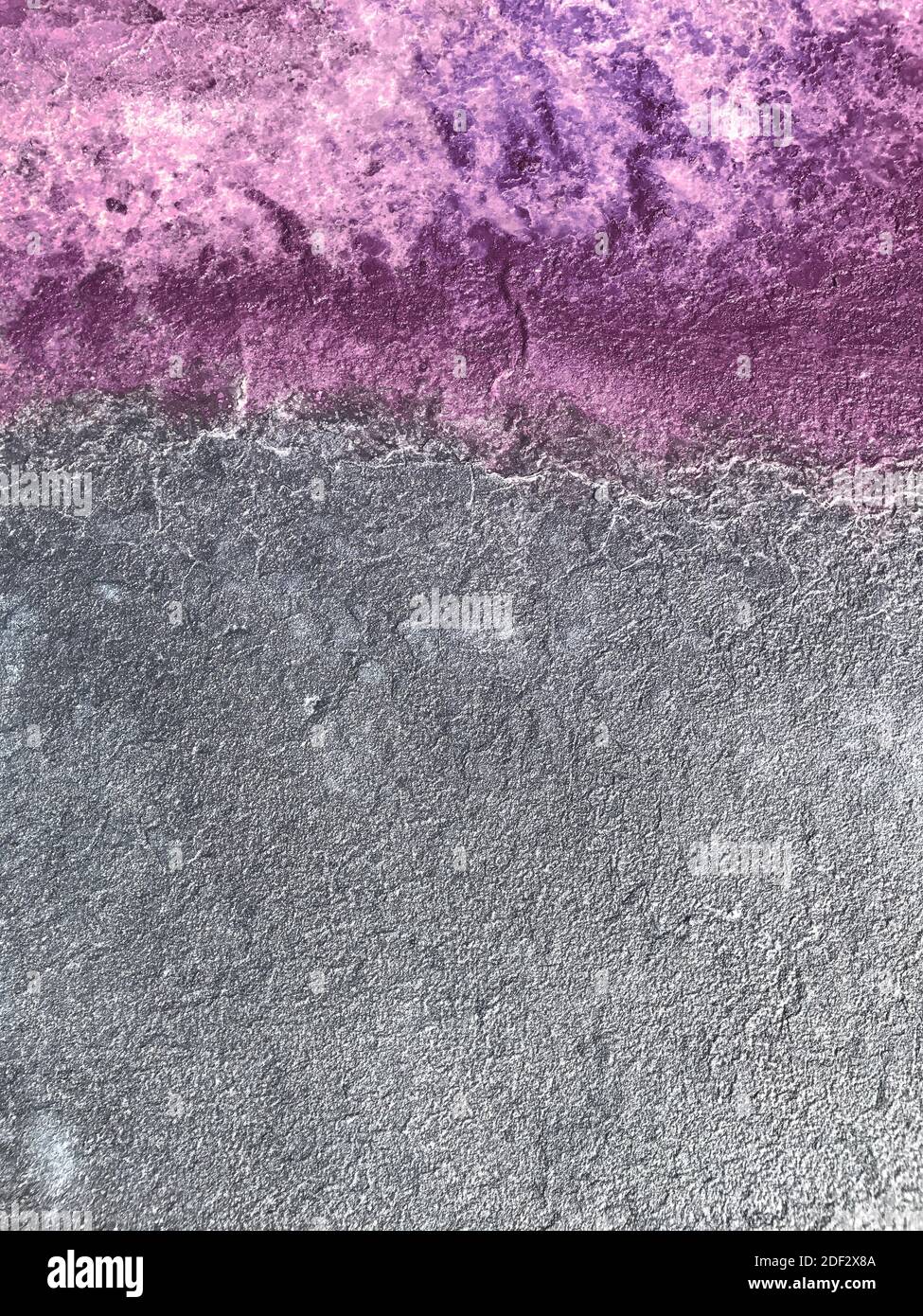 Grey concrete surface with splash of Amethyst colored paint. Abstract ...