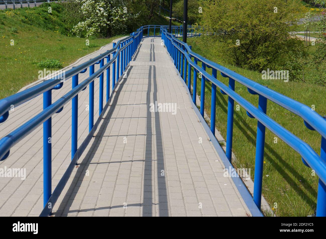 A path leading to a green park during daytime Stock Photo - Alamy