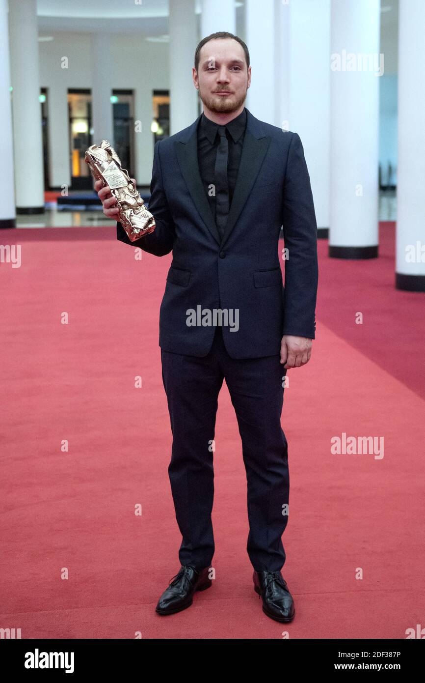 Alexis Manenti poses with the Best Newcomer award for the movie Les ...