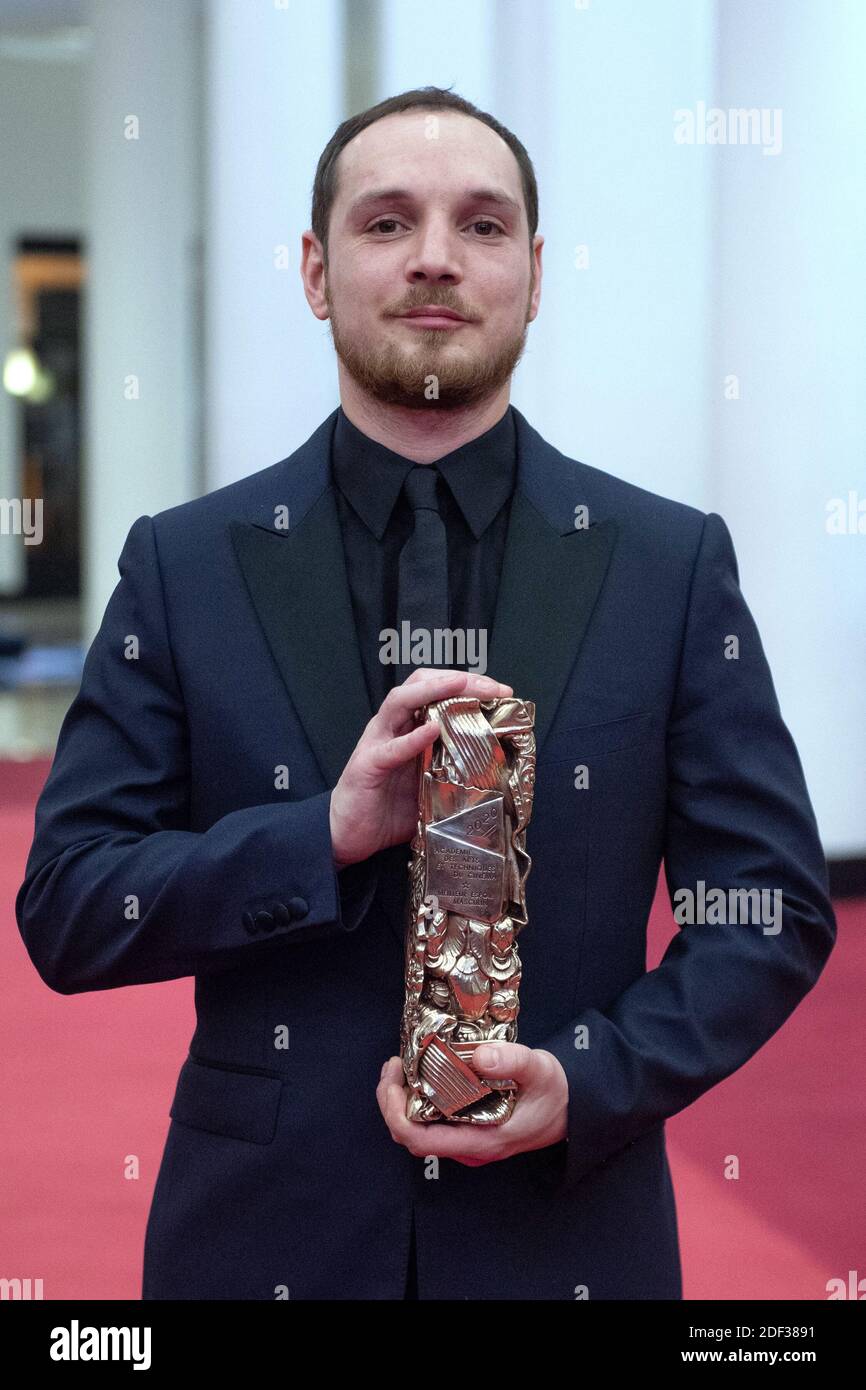 Alexis Manenti poses with the Best Newcomer award for the movie Les ...