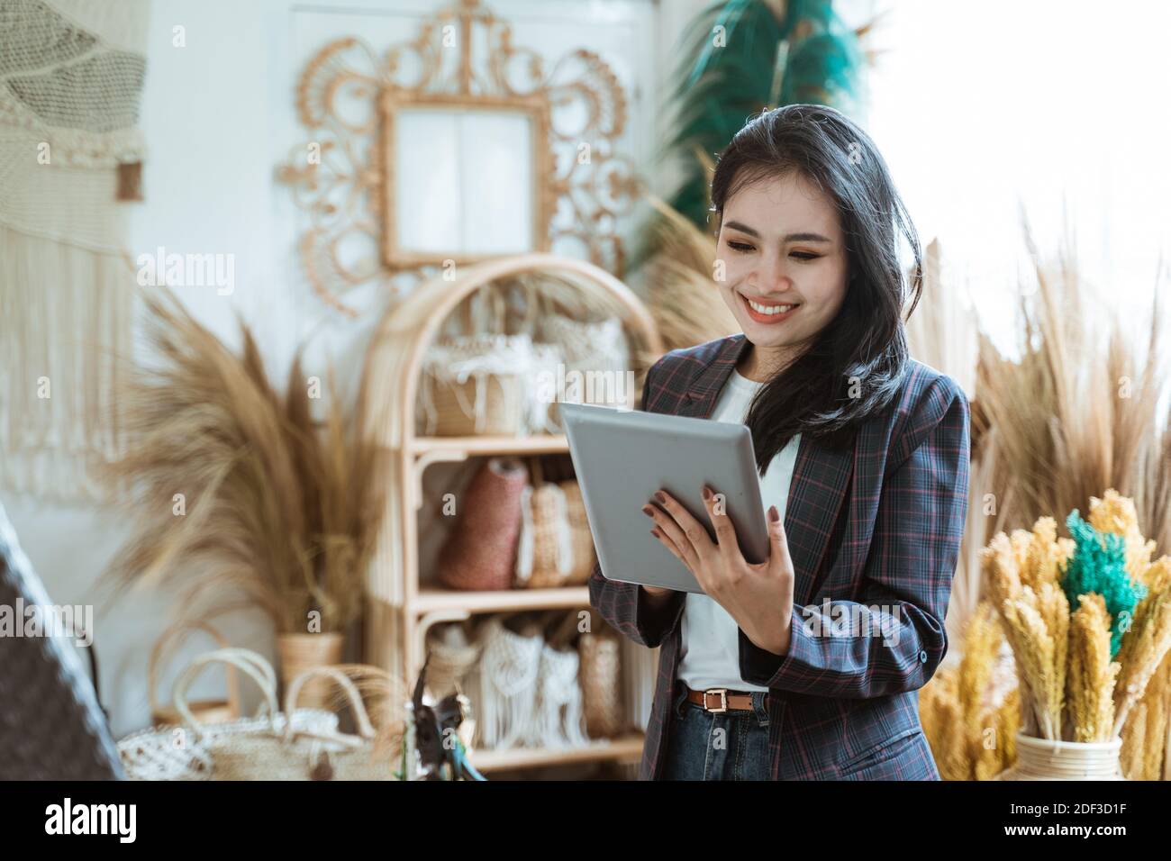 attractive asian business owner at her art and craft store selling ...