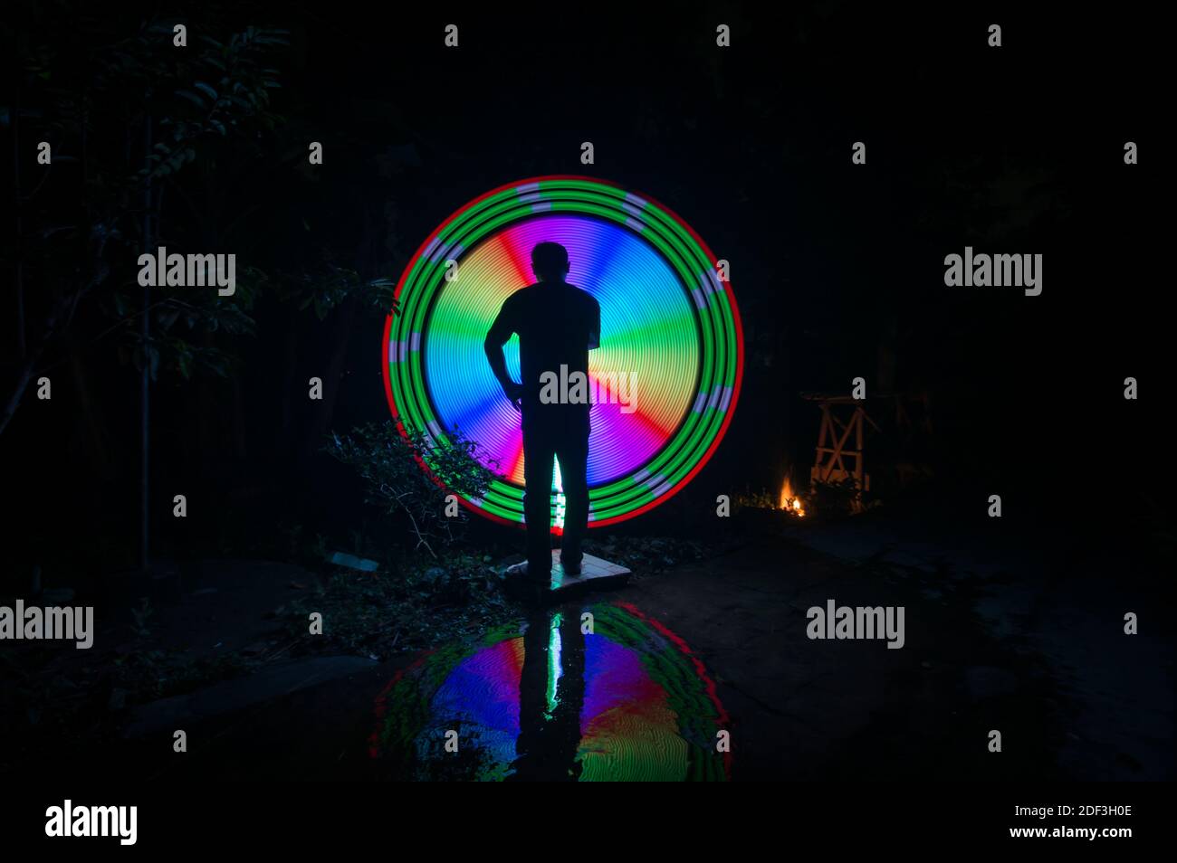 One person standing alone against beautiful color circle LED light ...
