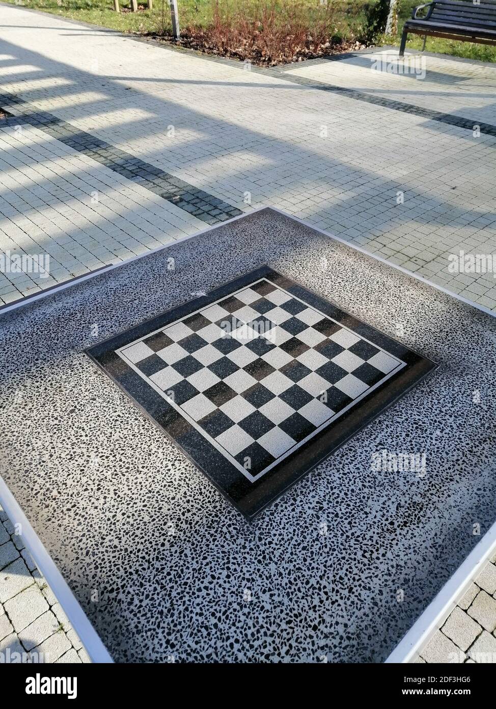 Vertical high angle shot of a chess board on the table in the yard ...