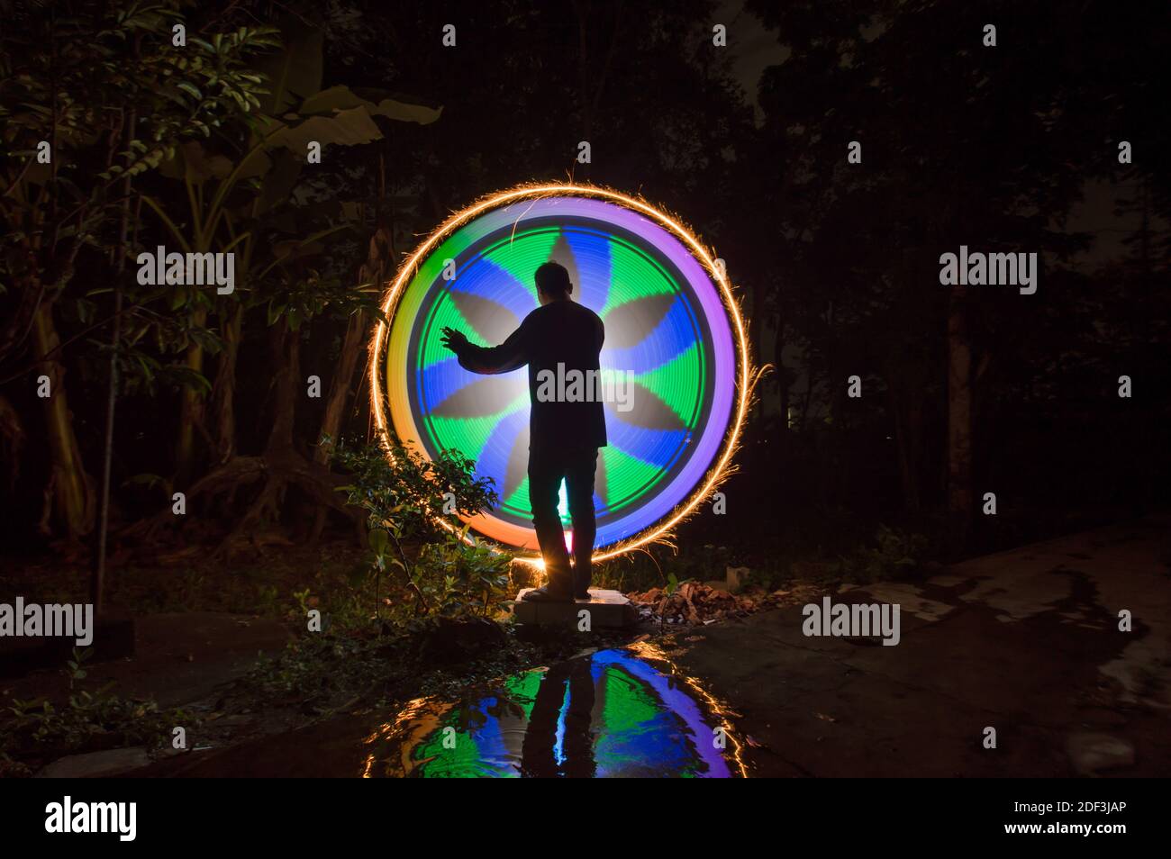 One person standing alone against beautiful color circle LED light ...