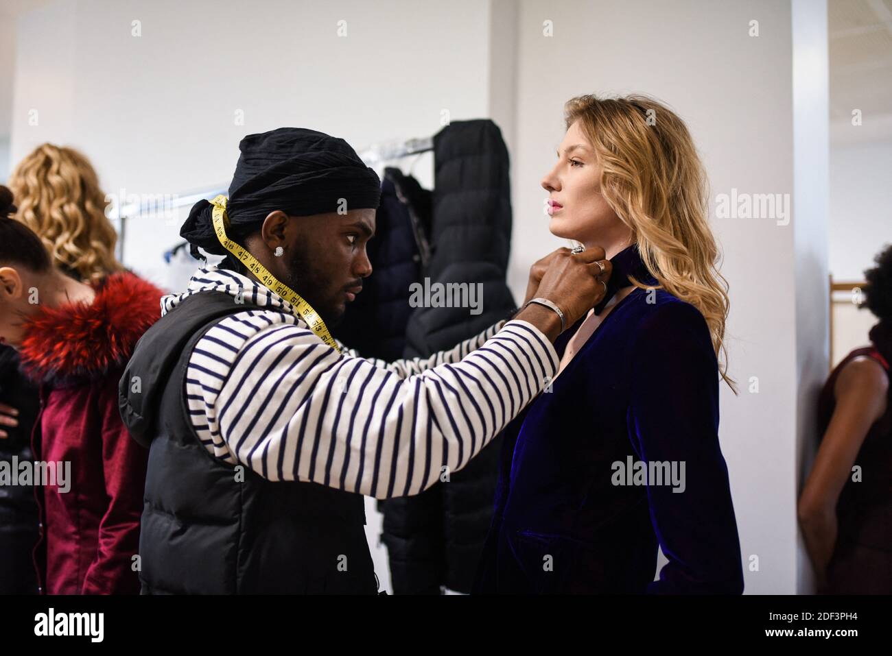Roby dresses a model before the Kipre couture Fall Winter 2020 show on ...