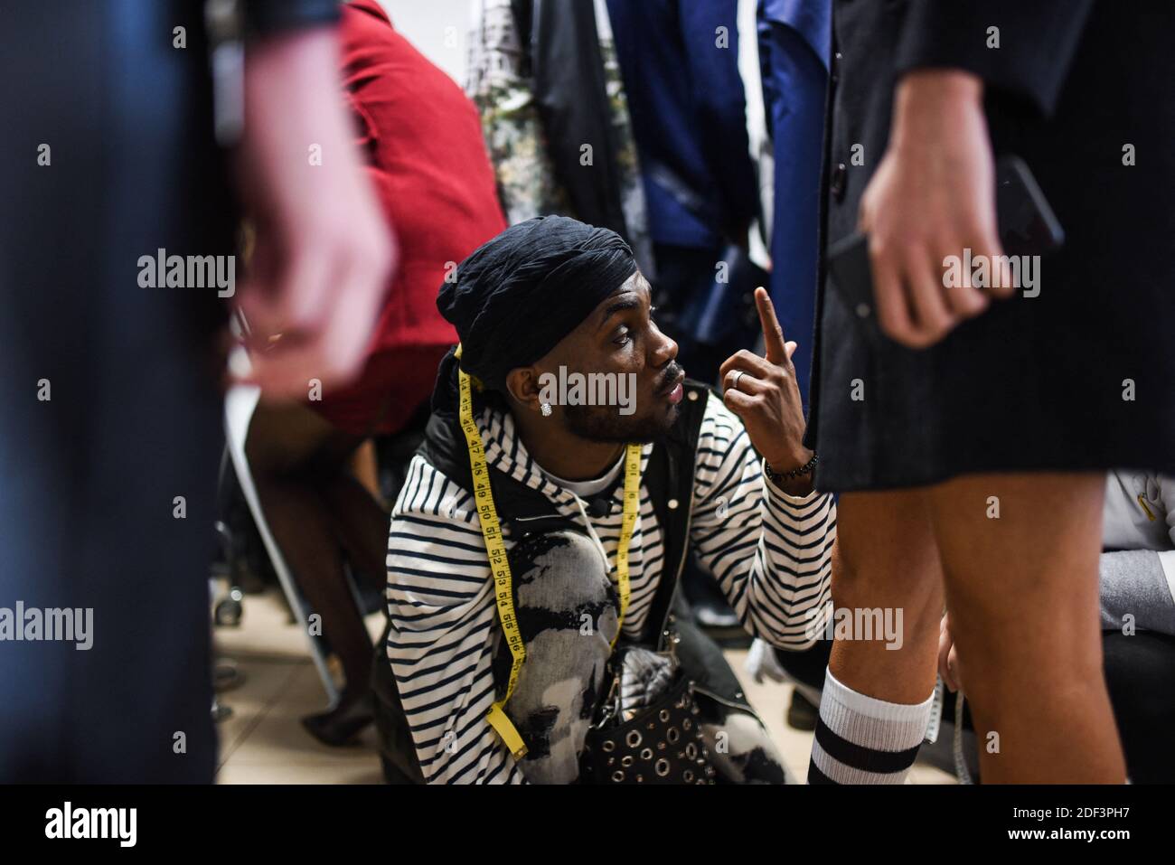Roby dresses a model before the Kipre couture Fall Winter 2020 show on ...