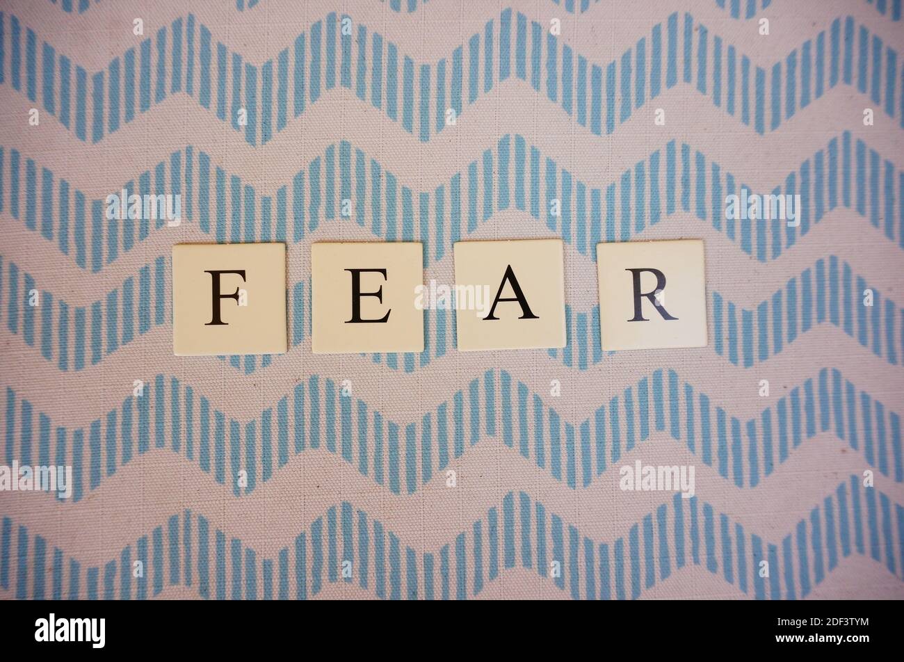The word fear written by letters on small squares on a blue and white ...