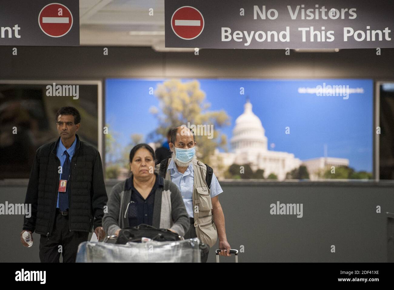 Passengers arrive from Dubai after a 14-hour flight on Emirates flight ...