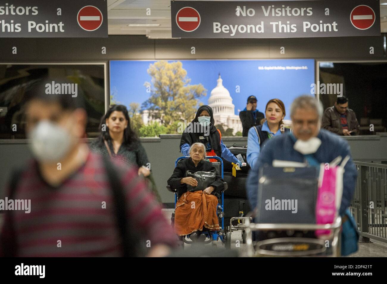 Passengers arrive from Dubai after a 14-hour flight on Emirates flight ...