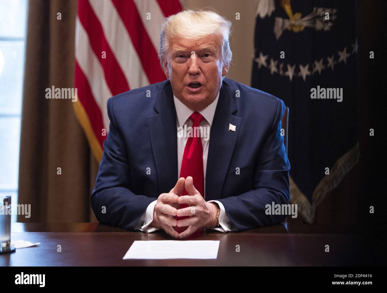 President Donald Trump speaks to reporters as he holds a meeting with ...