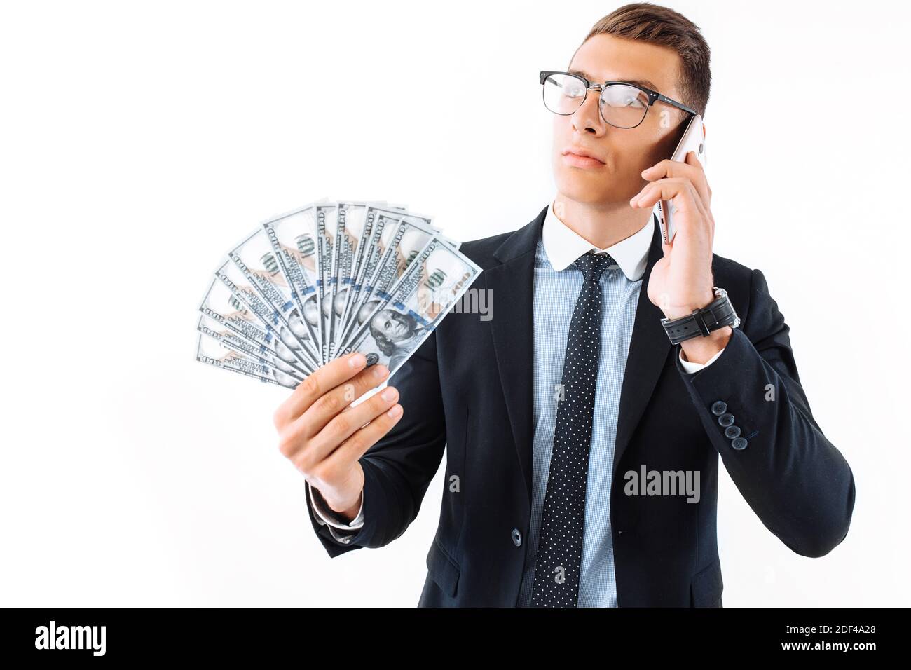 Successful businessman in glasses and suit, talking on the phone ...