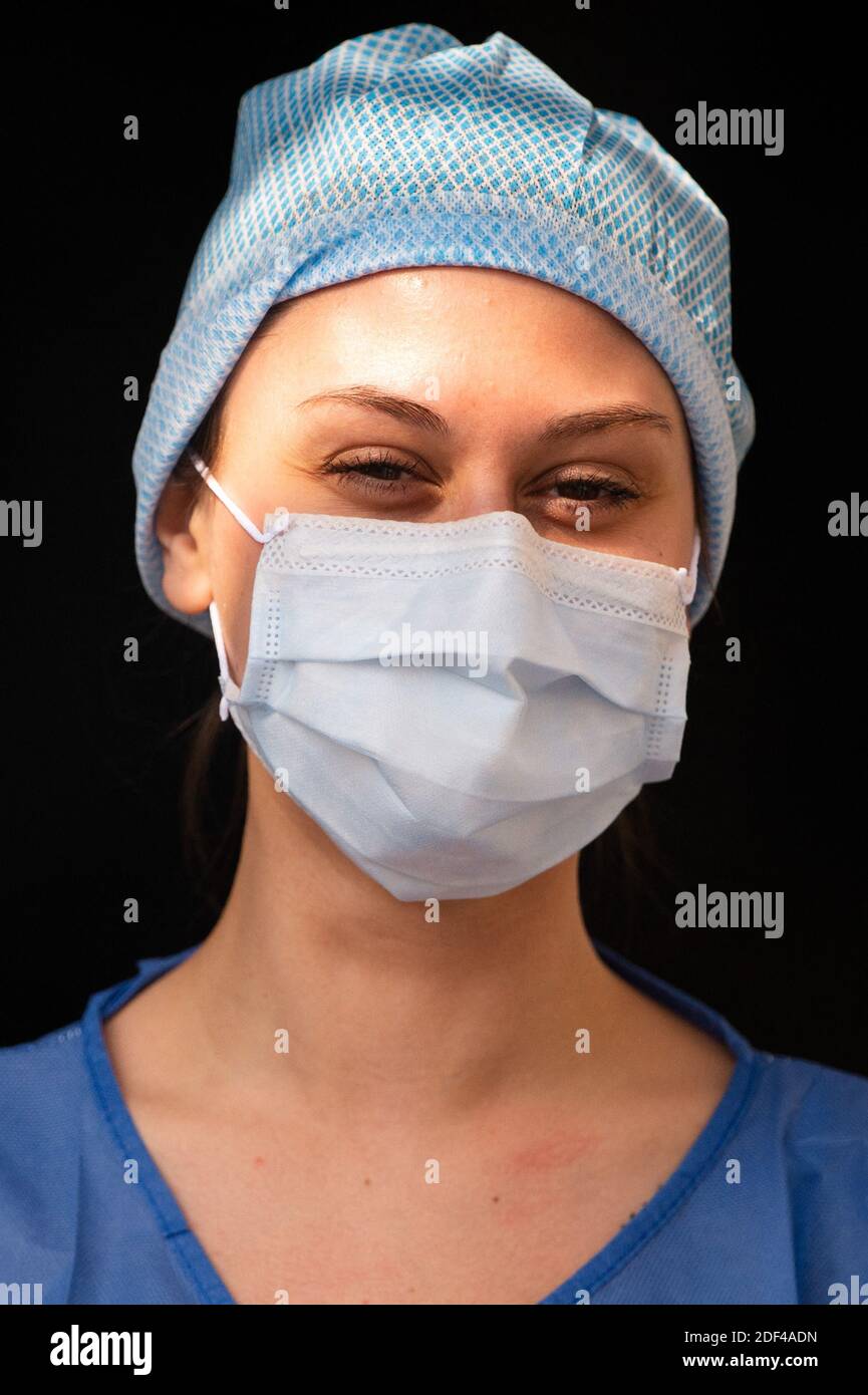 Portrait of a nurse wearing protective mask and body combination look ...