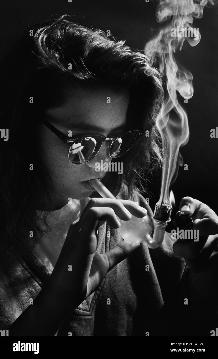 A young teenage girl simulates smoking a crack pipe. ** THE GIRL IS A ...