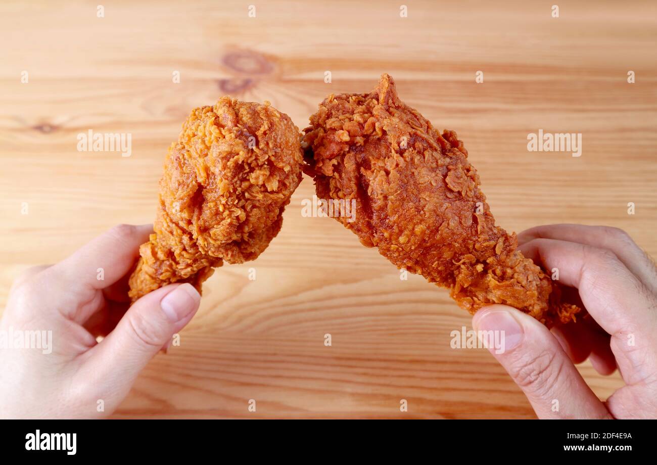 People's Hand Clinking Crispy Fried Chicken Drumsticks Stock Photo - Alamy