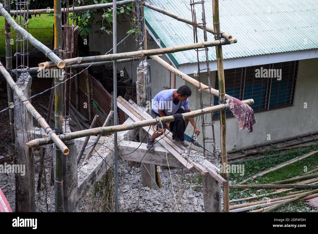 Dumaguete, the Philippines - 25 Oct 2020: worker on concrete tower ...