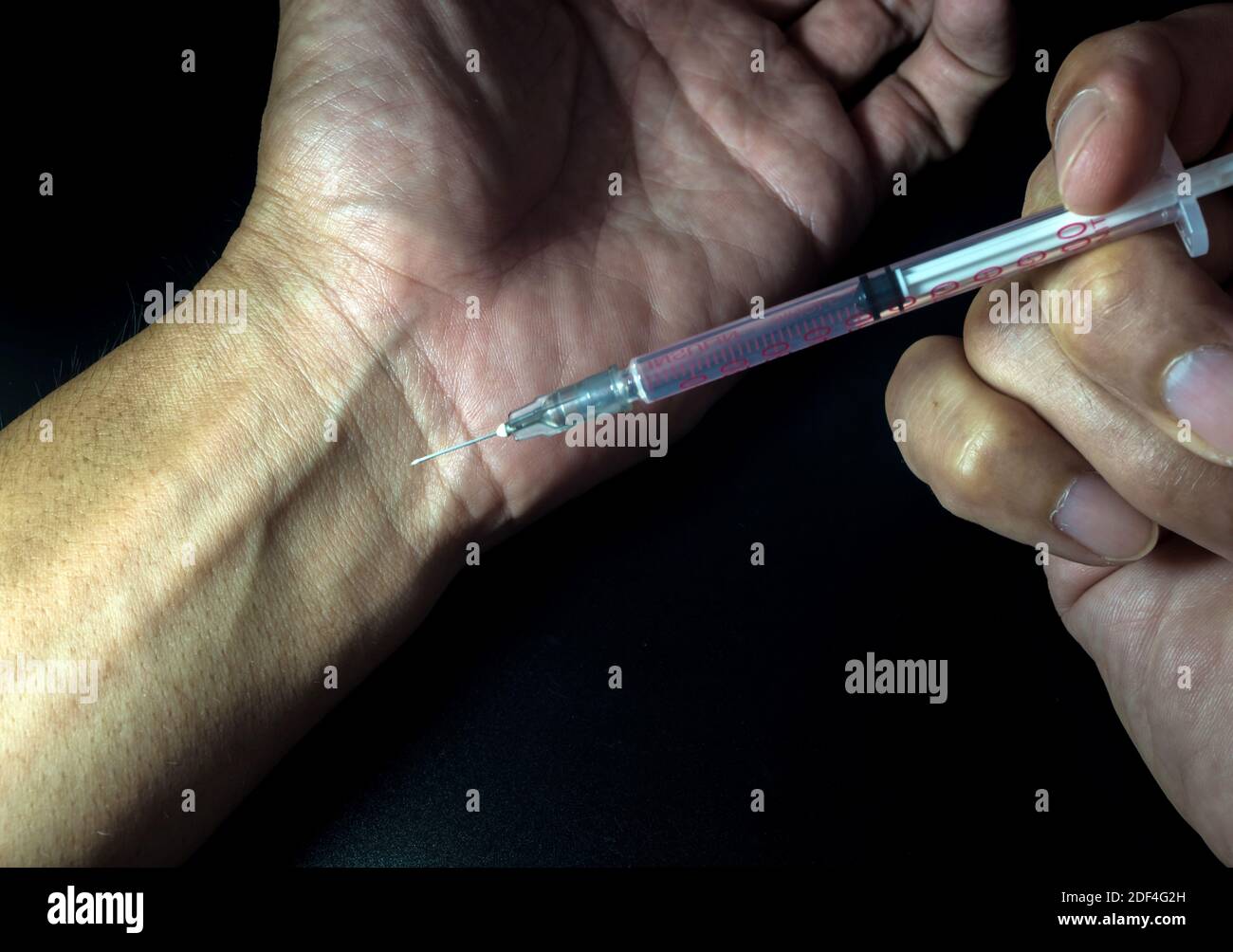 Man injecting with a syringe to his hand Stock Photo - Alamy