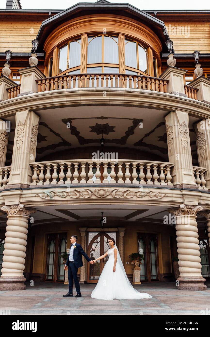 portrait of the bride and groom near the building Stock Photo - Alamy
