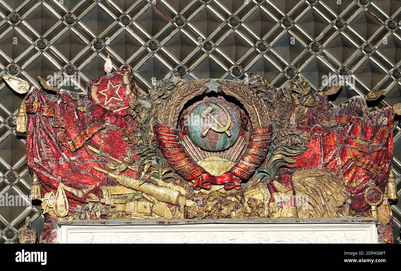 Photo of the bright Soviet coat of arms on the old building Stock Photo ...