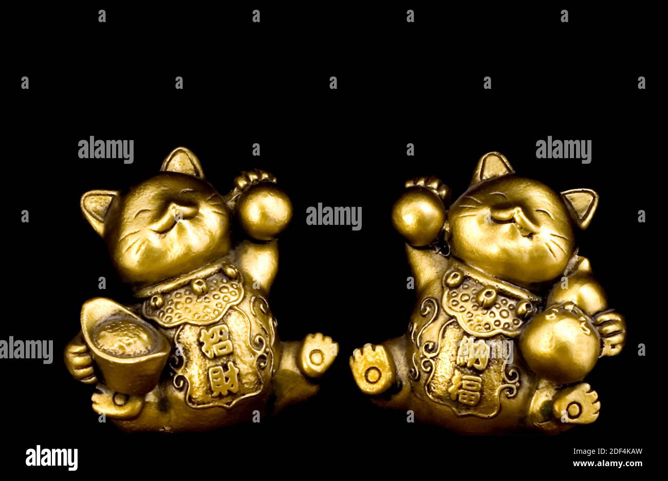 Gold Ceramic Maneki Neko Lucky Cats in black background. Beckoning Cats ...
