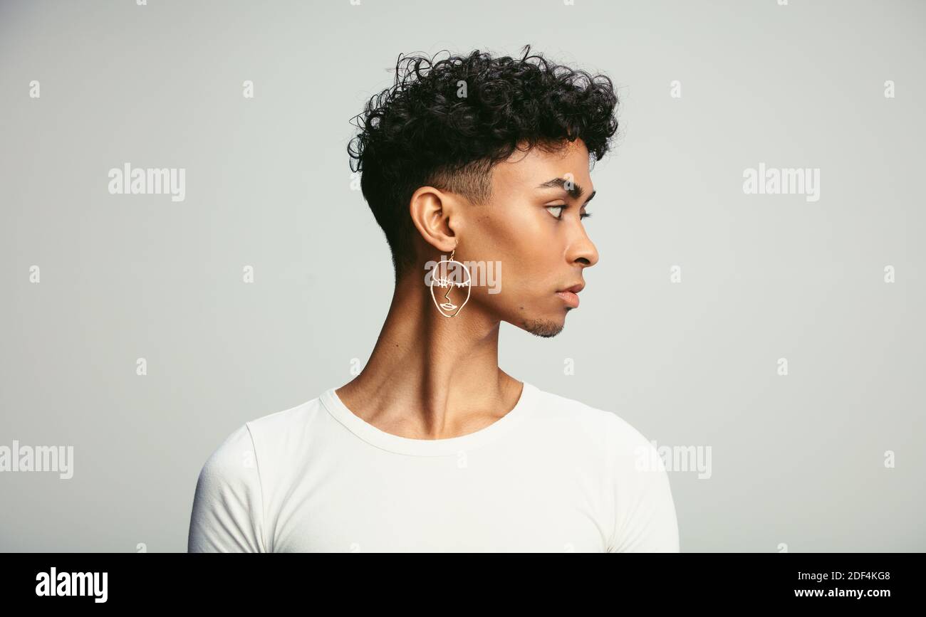 Profile shot of a gender fluid man wearing earring. Young androgynous ...