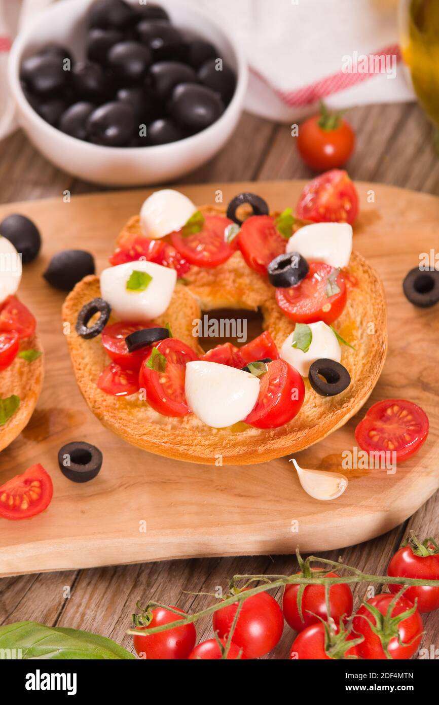 Friselle with tomatoes and mozzarella cheese Stock Photo - Alamy