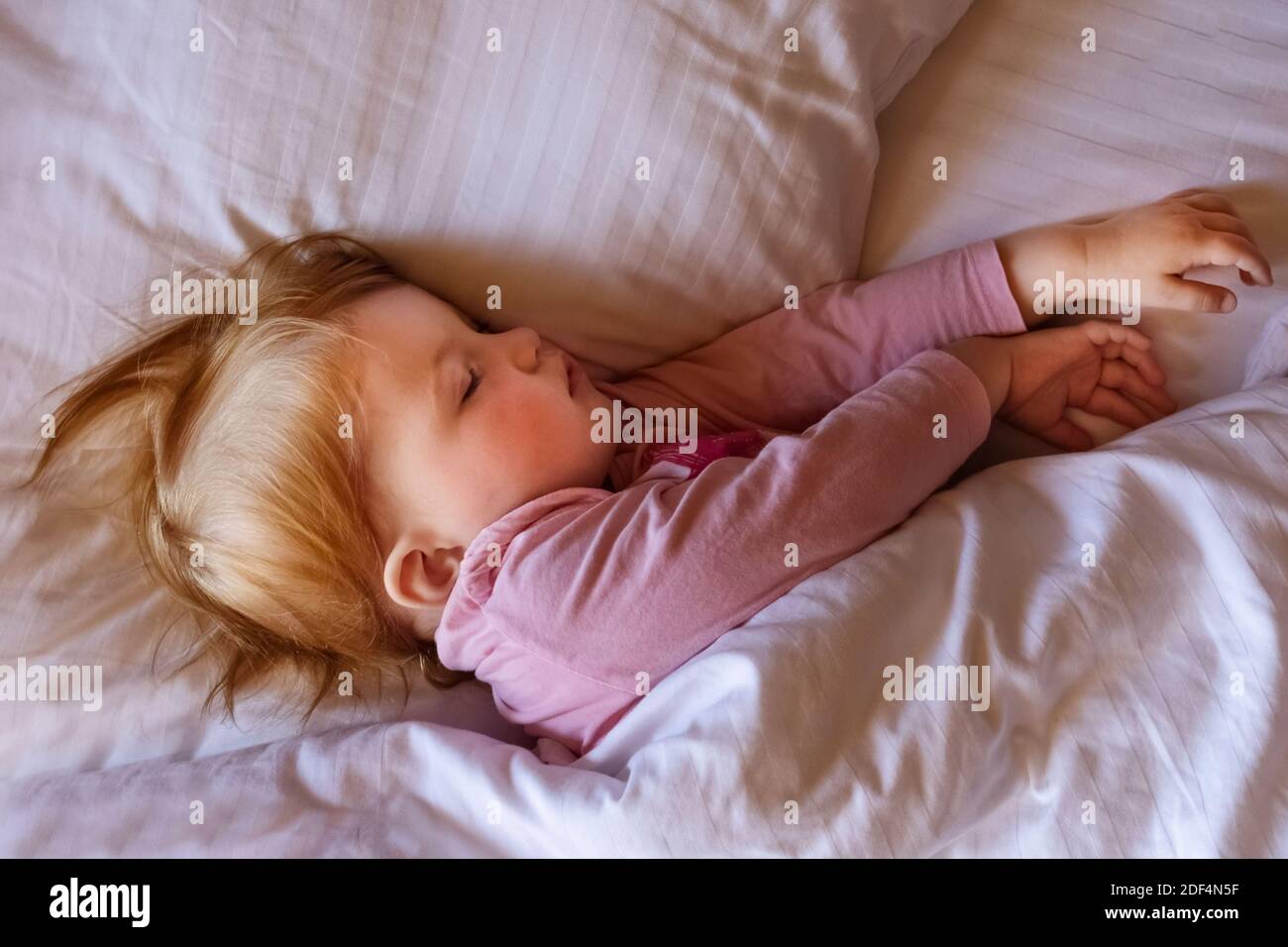 Child little girl sleeping in bed. Morning time Stock Photo - Alamy