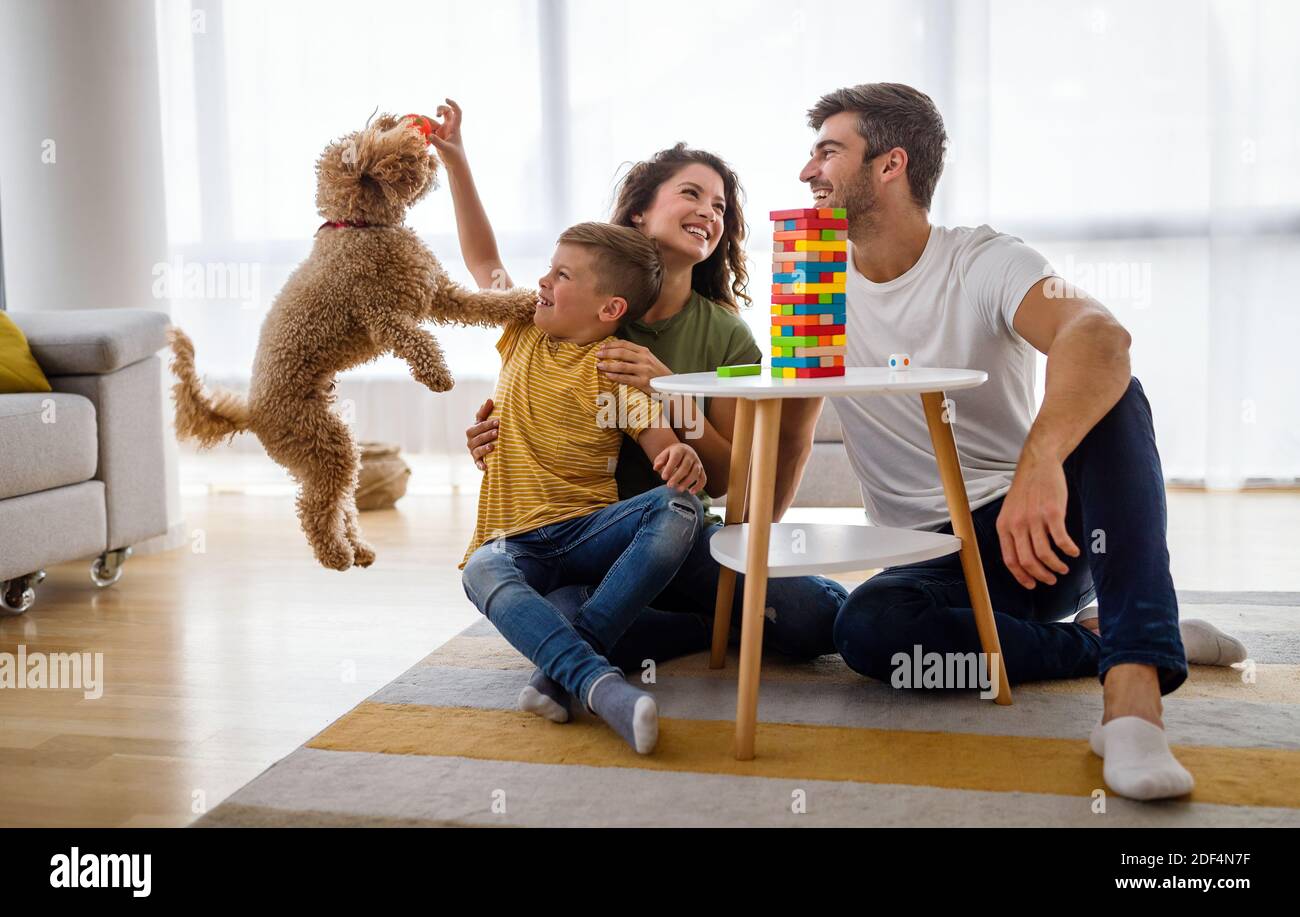 Young happy family having fun, playing together at home Stock Photo - Alamy