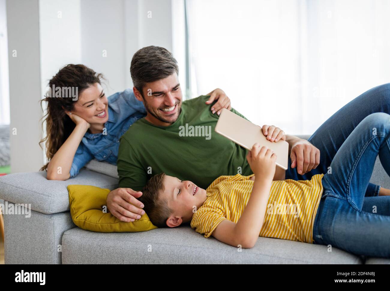 Happy family using technology devices together at home Stock Photo - Alamy