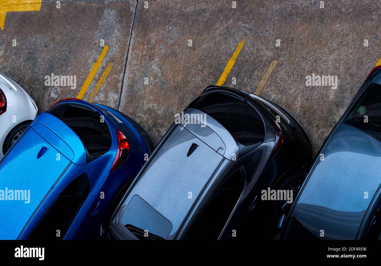 Top view of car parked at concrete car parking lot with yellow line of ...