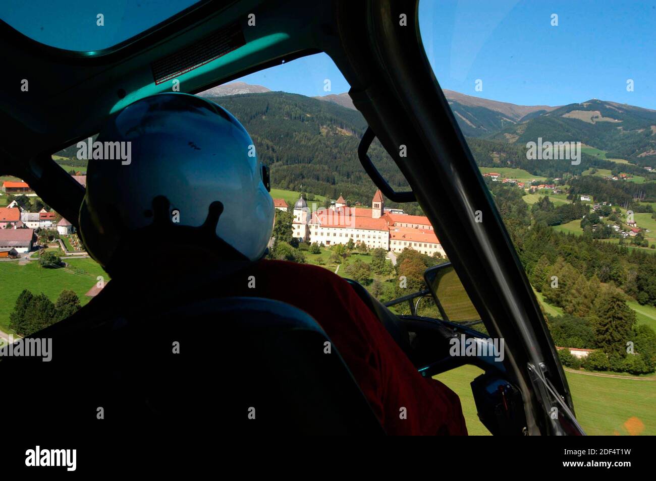 Pilot flying in a helicopter, viewing alpine landscape in summer Stock ...