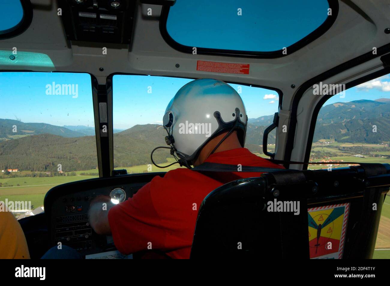 Pilot flying in a helicopter, viewing alpine landscape in summer Stock ...