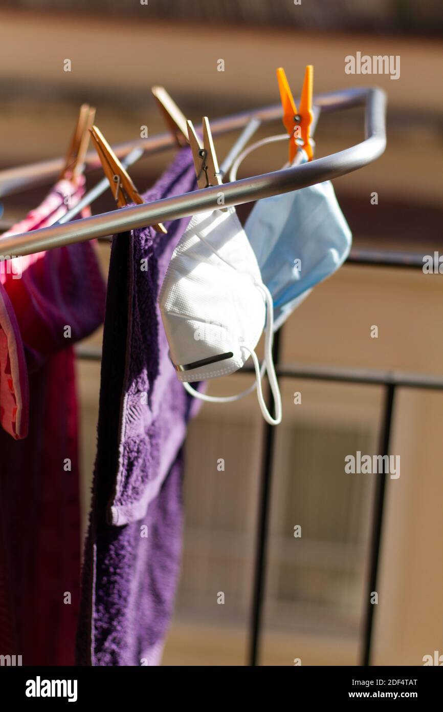 Two COVID-19 masks hanging on the portable drying rack for ventilation ...