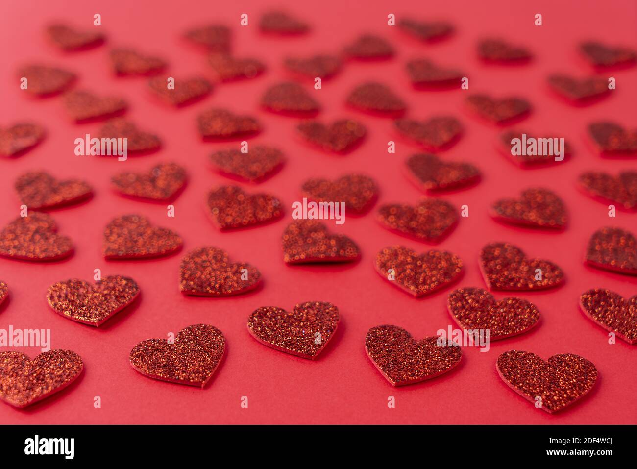 a texture formed with small red hearts on a red background Stock Photo ...