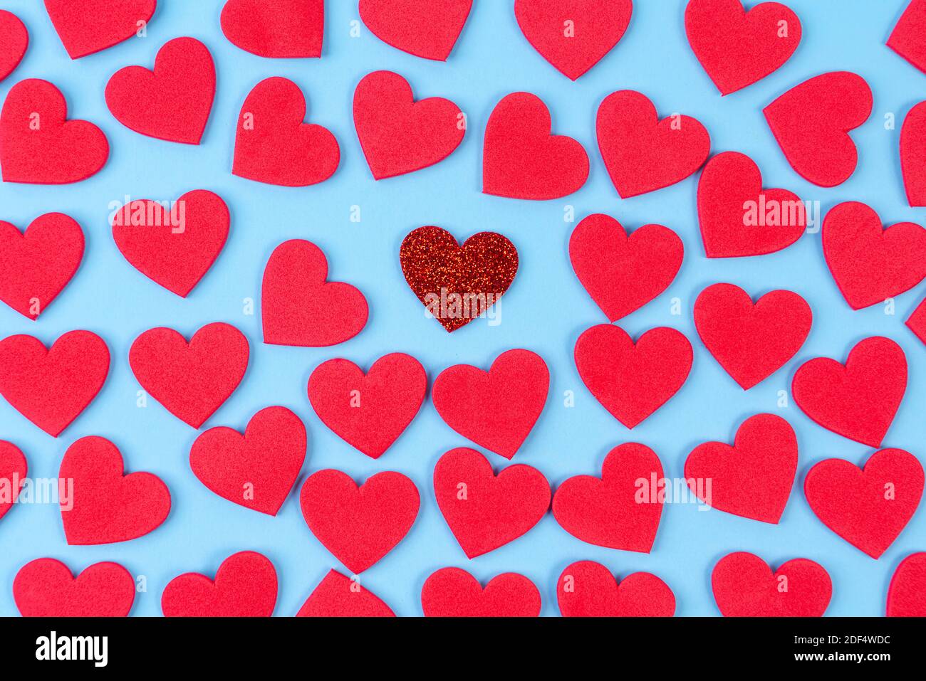 a texture formed with small red hearts on a blue background Stock Photo ...