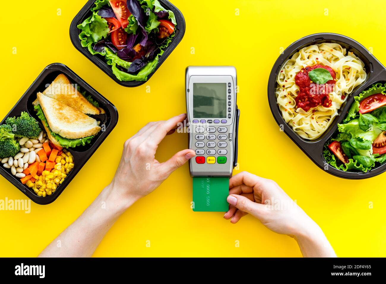 Hands with credit card and payment terminal. Restaurant food delivery ...