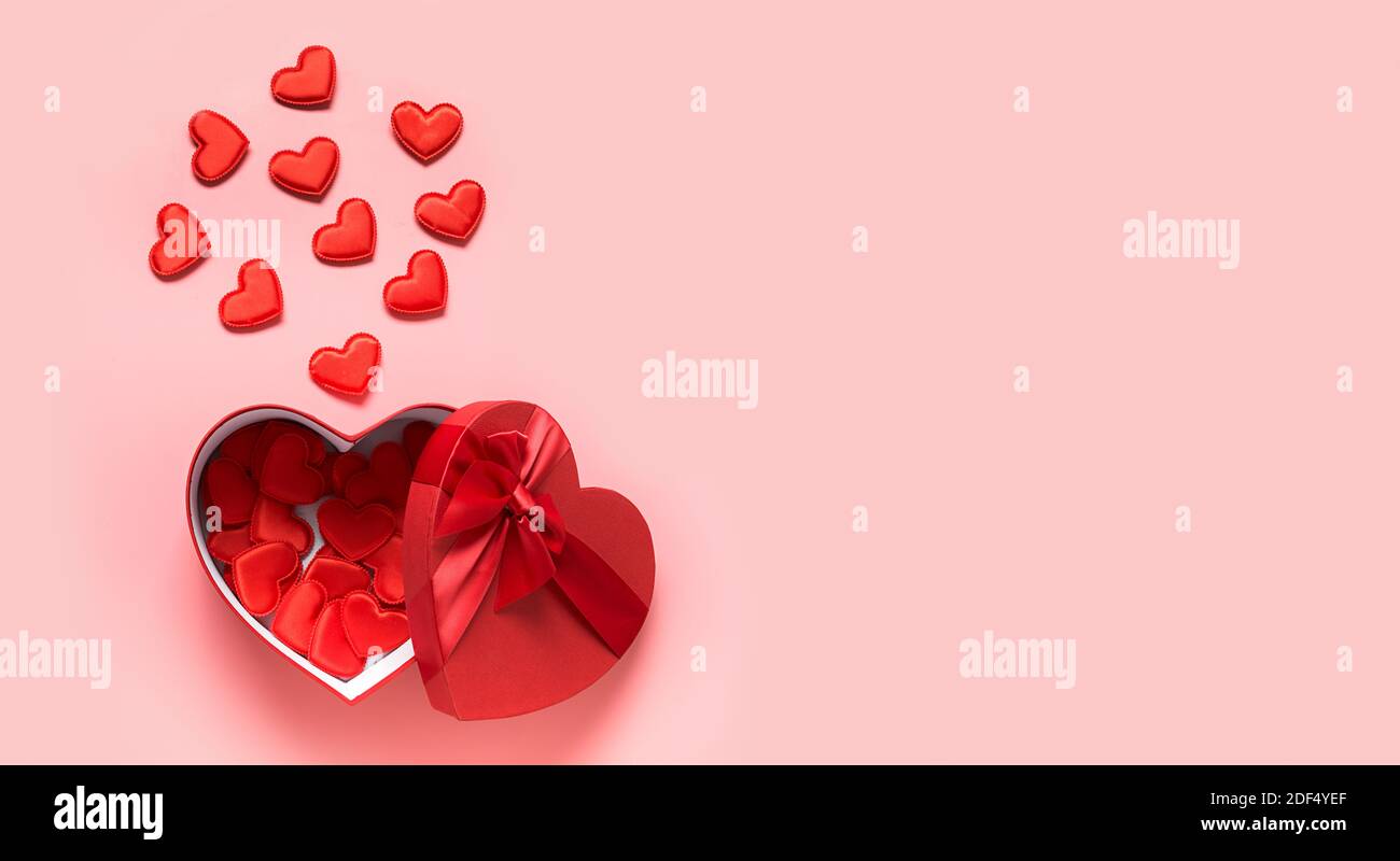Valentine's Day greeting card with open red box and hearts on pink ...