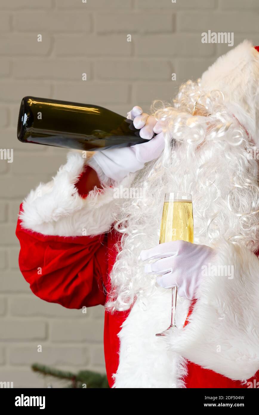 Santa claus drinking sparkling wine from bottle. drunk santa claus ...
