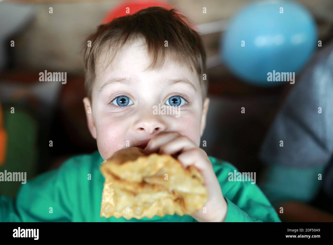 Boy eating cheburek in an asian restaurant Stock Photo - Alamy
