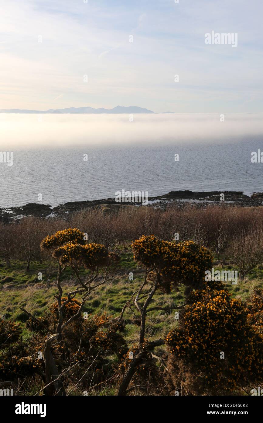 Dunure, Ayrshire, Scotland a sea mist or Harr floats above the Firth of ...