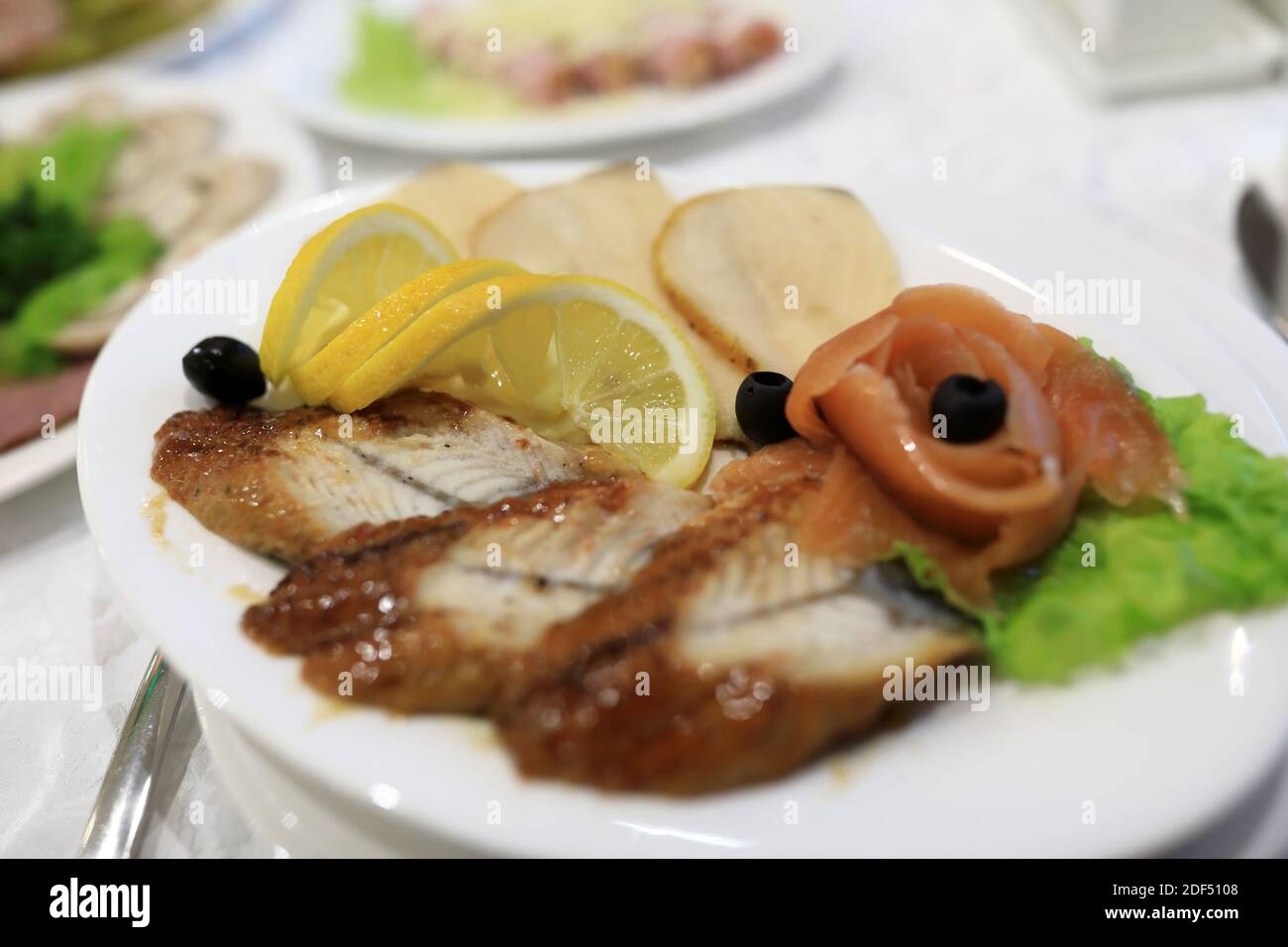 Fish sliced on plate in a restaurant Stock Photo - Alamy