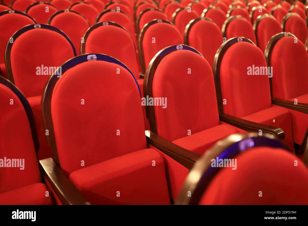 Details of row red chairs in cinema Stock Photo - Alamy