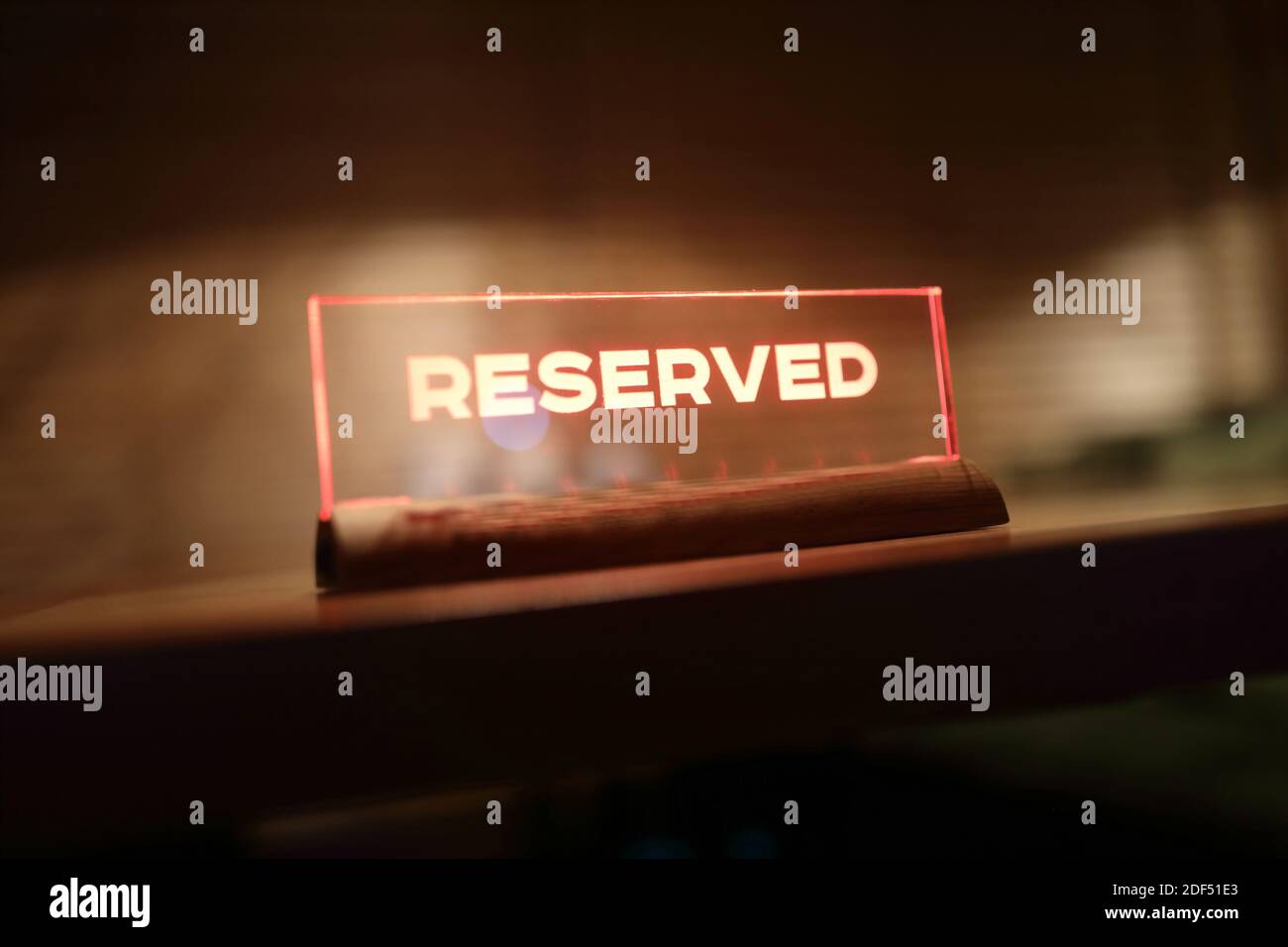 Red sign reserved in restaurant at night Stock Photo - Alamy