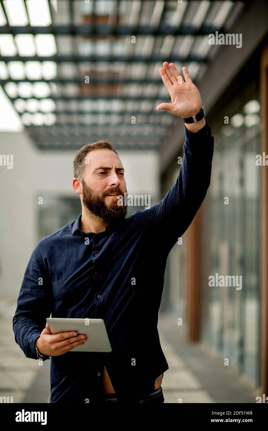 Modern businessman using tablet on pause Stock Photo - Alamy