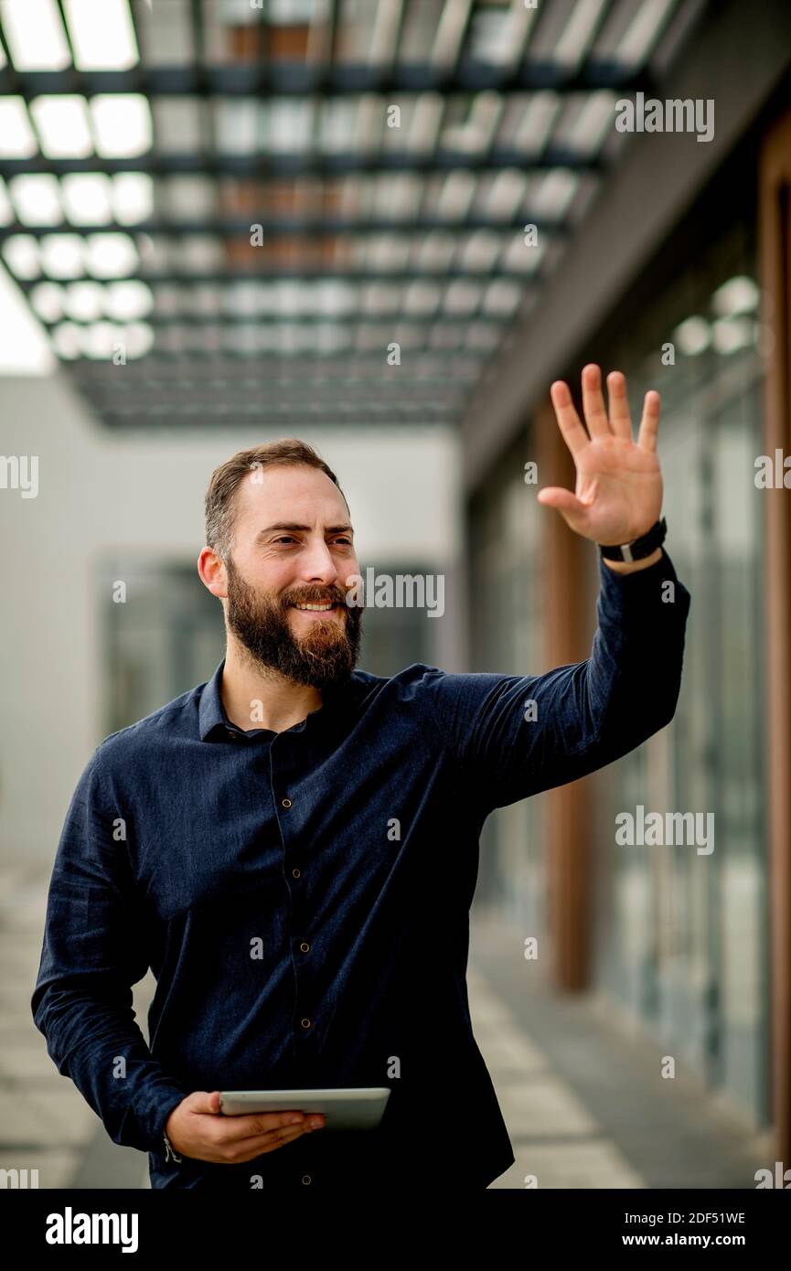 Modern businessman using tablet on pause Stock Photo - Alamy