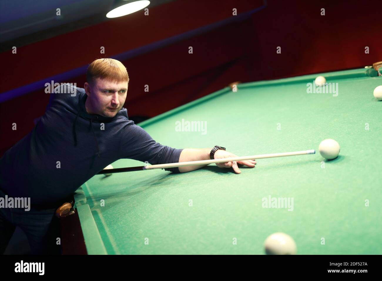 Portrait of man hits ball in billiards Stock Photo - Alamy