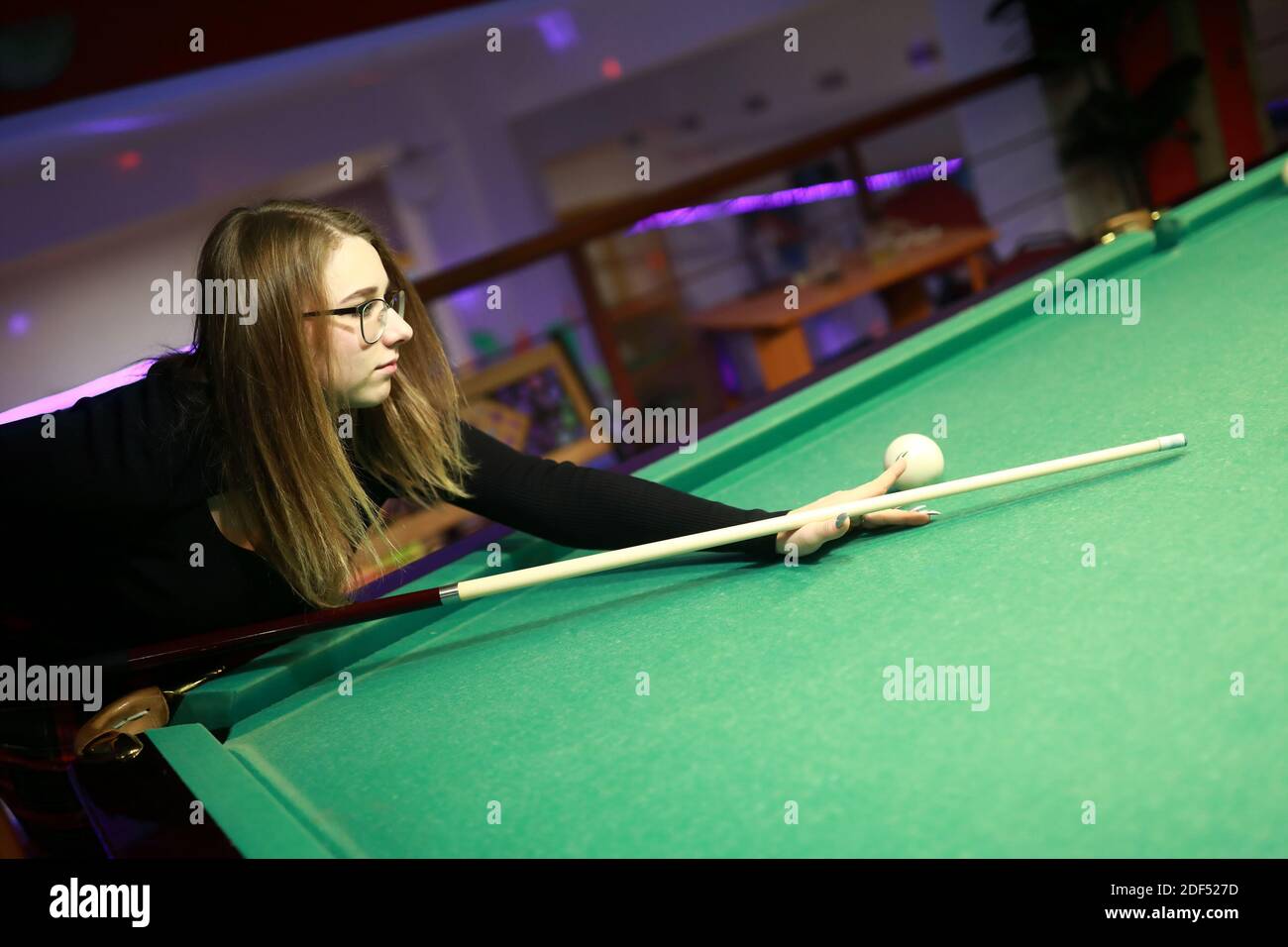 Portrait of teenager playing billiards at night Stock Photo - Alamy