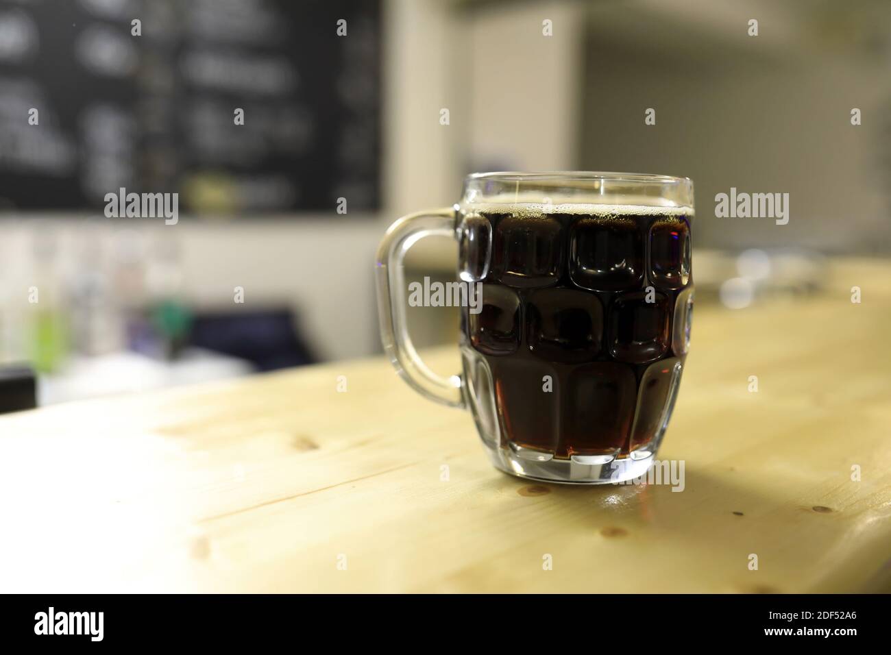 Stout mug at wooden bar in pub Stock Photo - Alamy