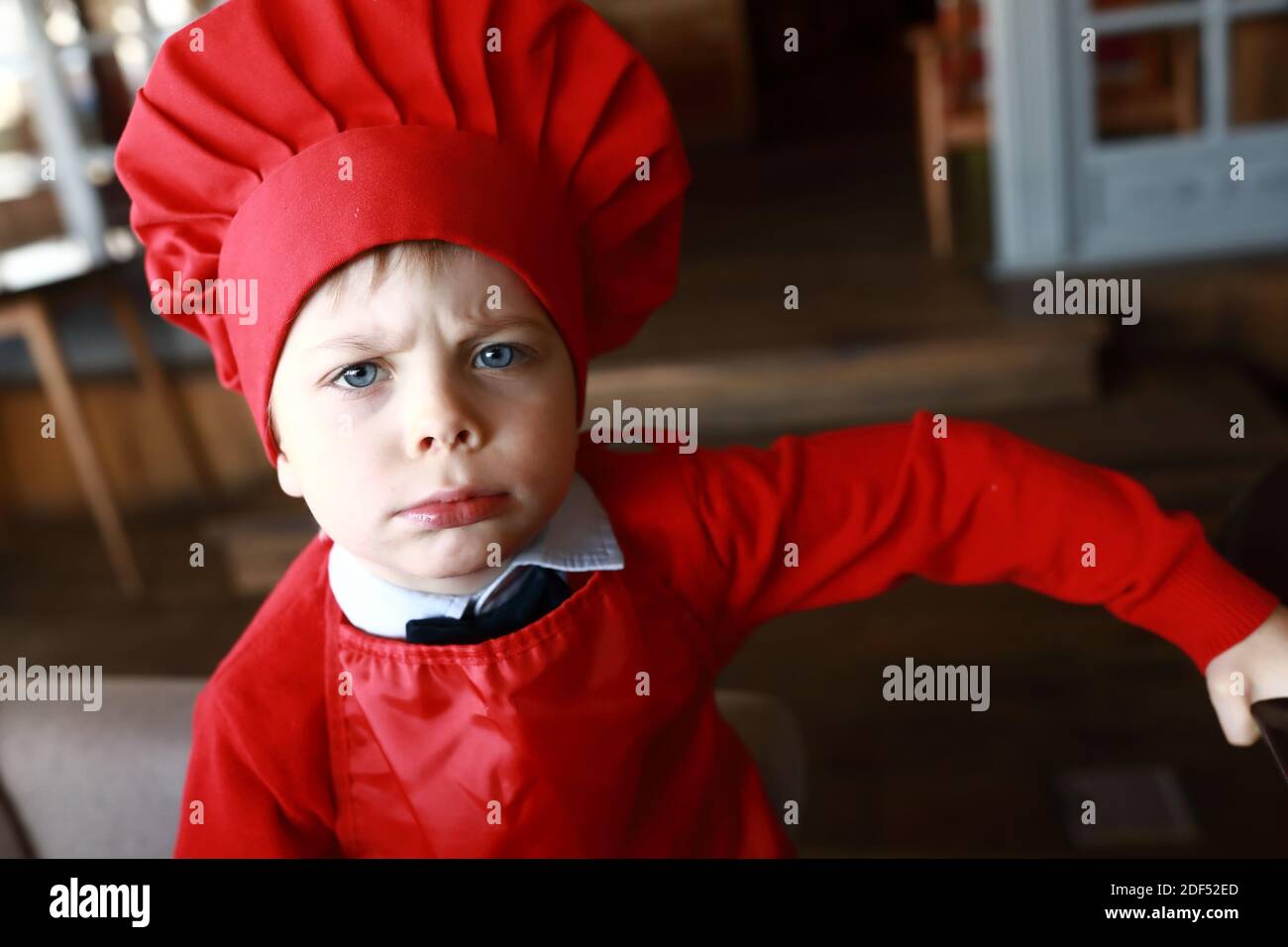 Portrait of boy in red cap cook Stock Photo - Alamy